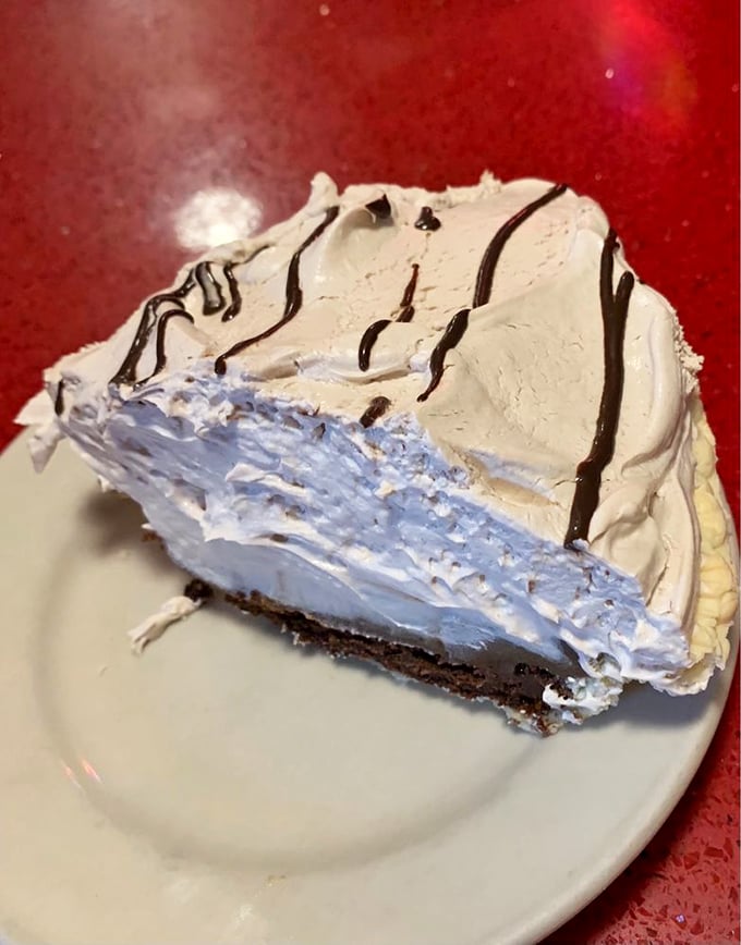 This cream pie doesn't just satisfy a sweet tooth—it recalibrates it. The chocolate drizzle is just showing off at this point.