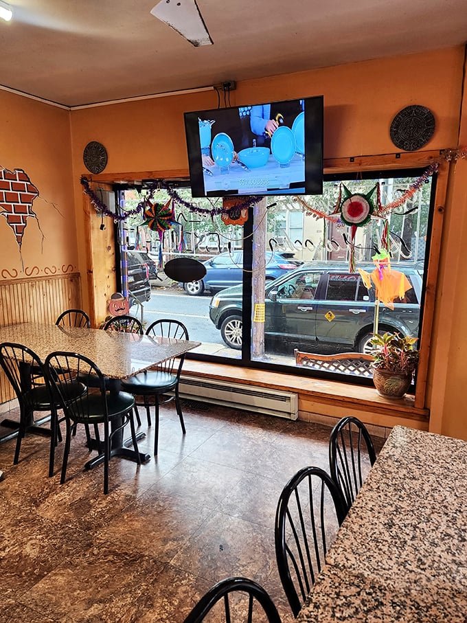 Those colorful decorations aren't for tourists—they're reminders of home. The TV in the corner says, "Stay awhile, you're family now."