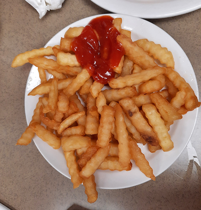 French fries that achieve that perfect golden state – crisp exterior, fluffy interior, and just begging for a ketchup companion.