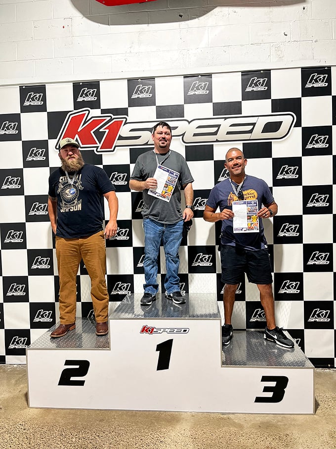 Victory tastes sweetest from the top step of the podium. Three grown men experiencing the pure joy usually reserved for eight-year-olds.