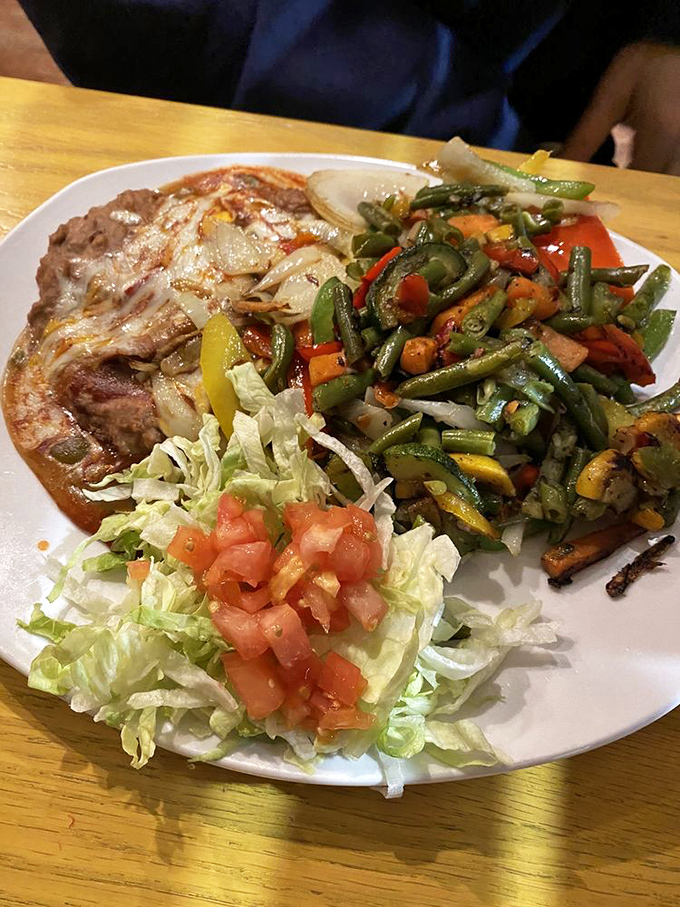 A plate that says "I contain multitudes"—vegetables that haven't been cooked into submission, beans with dignity, and what appears to be a perfectly grilled protein.
