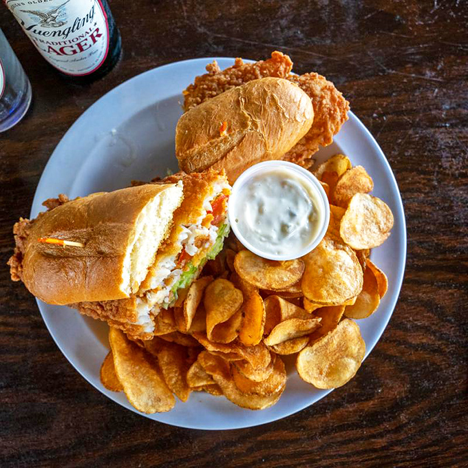 The perfect lunch trinity—golden bread, crispy chips, and a sandwich that doesn't need Instagram filters to look absolutely stunning.