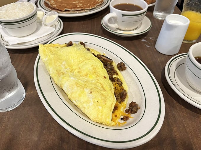 This omelet doesn't just contain cheese and sausage – it celebrates them in a fluffy yellow package that's worth setting your alarm for.