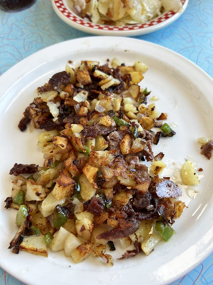 These hash browns aren't just cooked—they're engineered for optimal pleasure, with crispy edges and bits of delicious add-ins creating texture paradise.