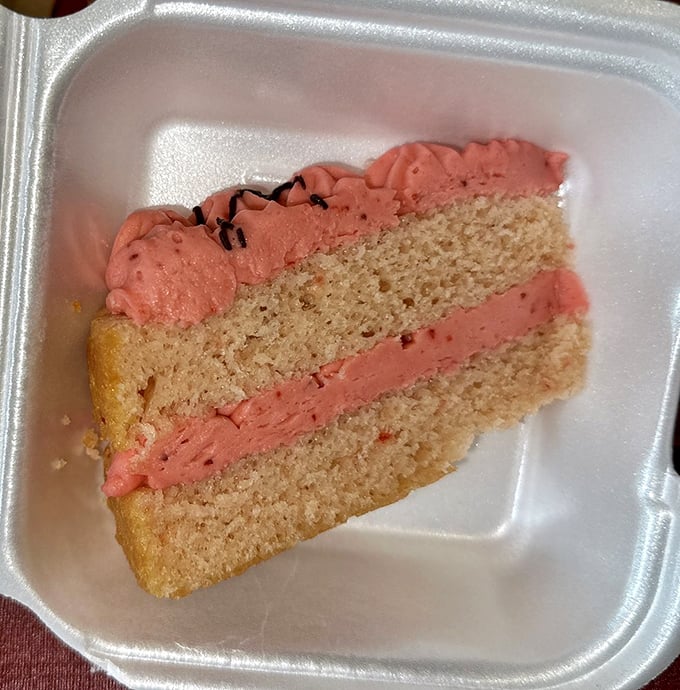 A slice of strawberry cake that doesn't need fancy decorations to make its point—just honest-to-goodness flavor that would make grandma proud.