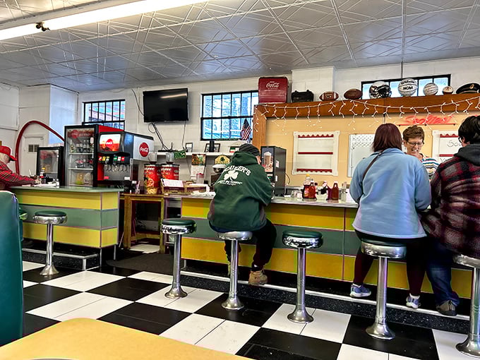 The counter seating – where solo diners become regulars and servers remember how you take your coffee before you sit down.