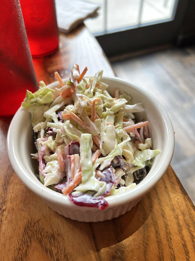 This isn't just coleslaw—it's a palate cleanser between bites of fried glory, a crisp, creamy counterpoint to all that Southern-fried decadence.