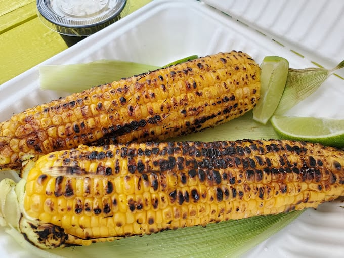 Elote – grilled corn elevated to art form. Those char marks aren't accidents; they're flavor autographs signed with fire and finished with lime.