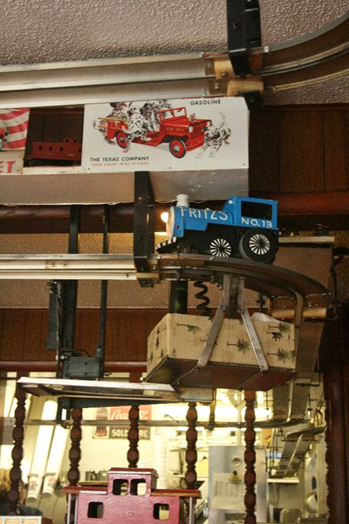 All aboard! The miniature train delivery system—Fritz's claim to fame—carries your burger overhead like royalty on rails.