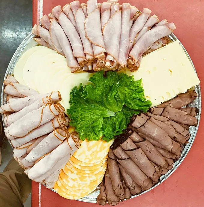 A meat and cheese platter arranged with no-nonsense Midwestern practicality – the foundation of any respectable gathering in central Missouri.