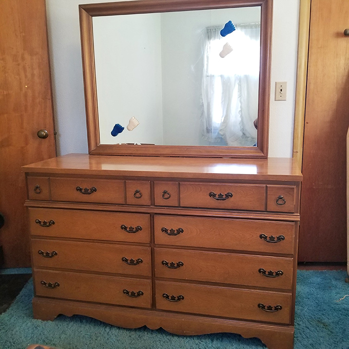 Grandma's dresser with mirror—where generations of Oklahomans checked their reflections before church, first dates, and job interviews. Solid wood, solid memories.