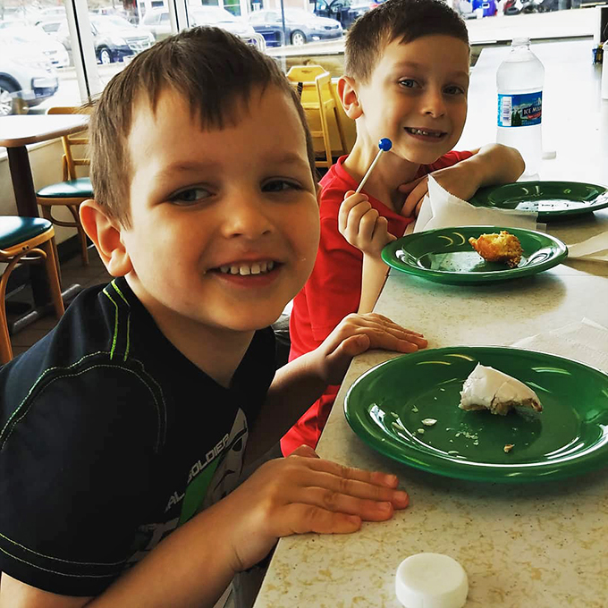 Future food critics in training discover the universal truth: donuts create happiness at any age. The joy is absolutely contagious.