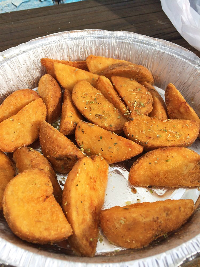 These aren't just fries—they're potato wedges that went to finishing school in Athens. The seasoning is their graduation cap.