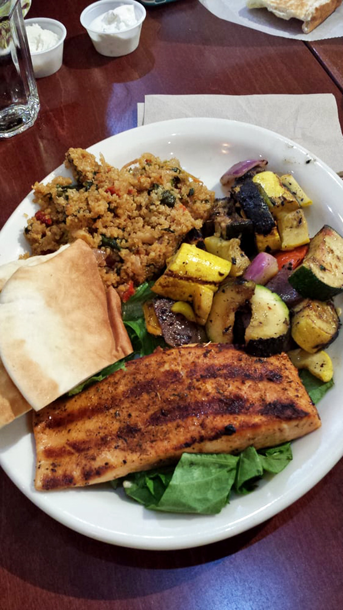 Not just salmon—it's the Meryl Streep of fish dishes. Perfectly grilled, served alongside vegetables and couscous that refuse to be overshadowed.