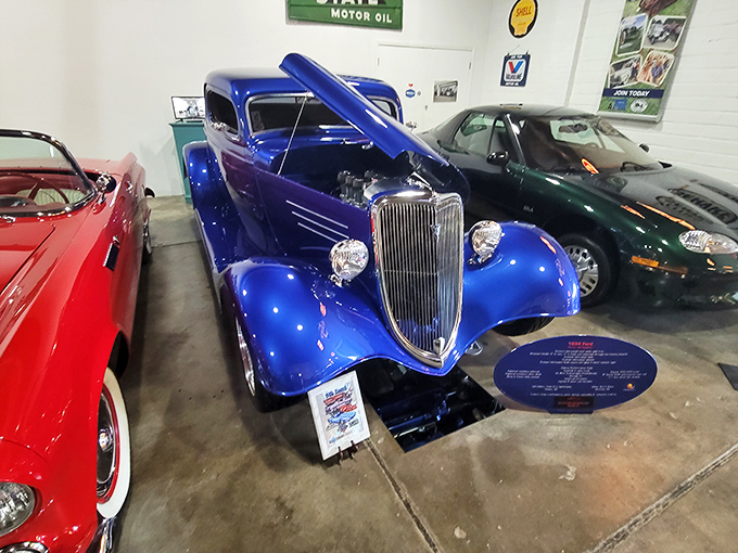 This electric blue 1932 Ford hot rod gleams under the lights – the kind of car that makes grown adults suddenly remember their teenage daydreams.