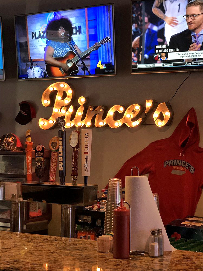 The illuminated Prince's sign watches over the bar like a spicy guardian angel, reminding you where hot chicken allegiance belongs.