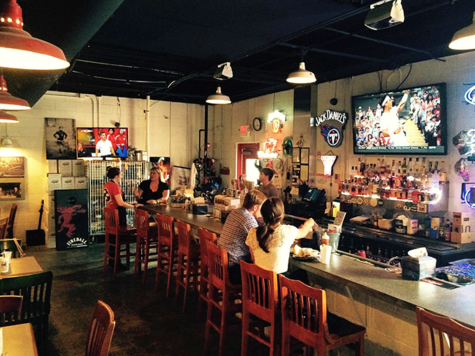 The bar area—where strangers become friends over bourbon and debates about dry rub versus sauce.
