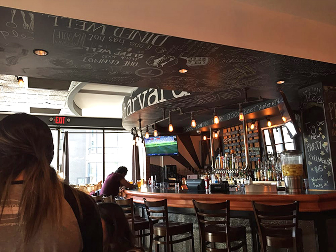 A bar that invites lingering, where sports play on screens and the chalkboard ceiling preserves the wit of customers past.