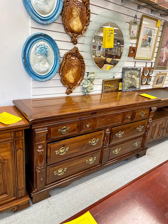 Vintage dressers lined with cameo portraits and decorative mirrors create an impromptu vanity museum where your reflection joins generations past.