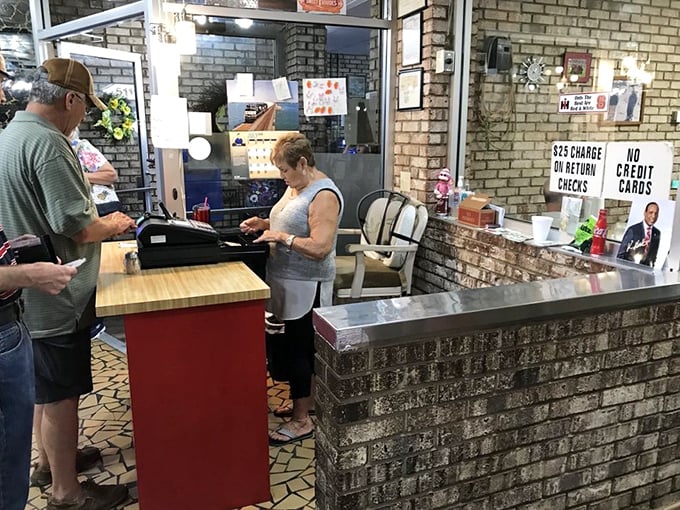 The heartbeat of Pam's Farmhouse—where orders are called, tabs are settled, and regulars always get a "hey, sugar" greeting.