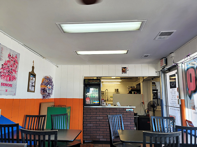 The ordering counter—that magical threshold where hunger meets its match. Orange walls frame the gateway to satisfaction.