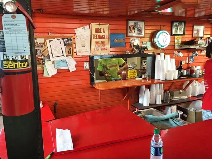 Behind every great hot dog joint is a wall of personality. That "Hire a teenager" sign speaks volumes about Monroe's no-nonsense charm.