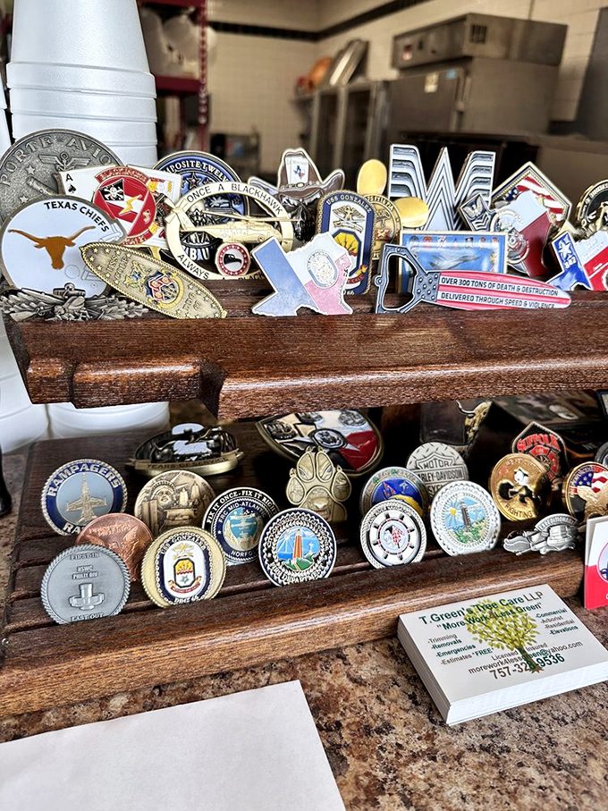A collection of challenge coins and Texas memorabilia—the barbecue equivalent of Olympic medals. Each one tells a story of smoked meat excellence.