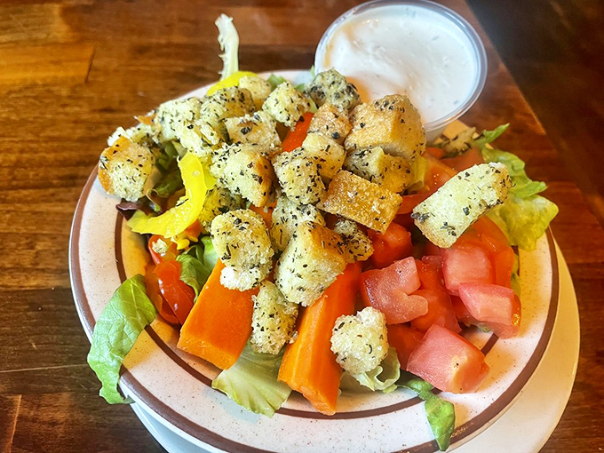 Even the salad gets special treatment here—fresh vegetables and house-made croutons that didn't come from a bag labeled "expires next year."