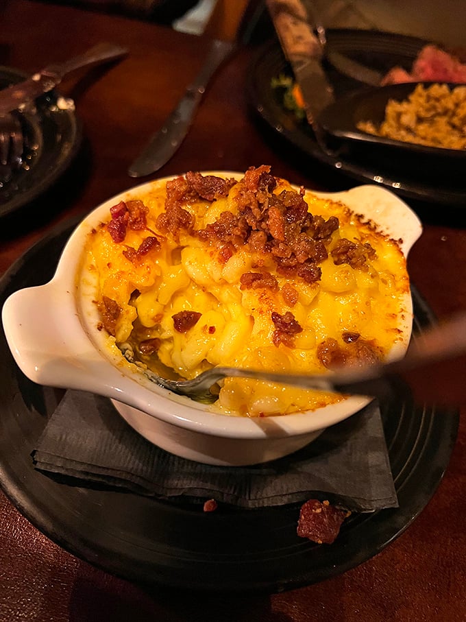 Mac and cheese with bacon crumbles that would make your cardiologist wince and your taste buds sing. Worth every calorie.