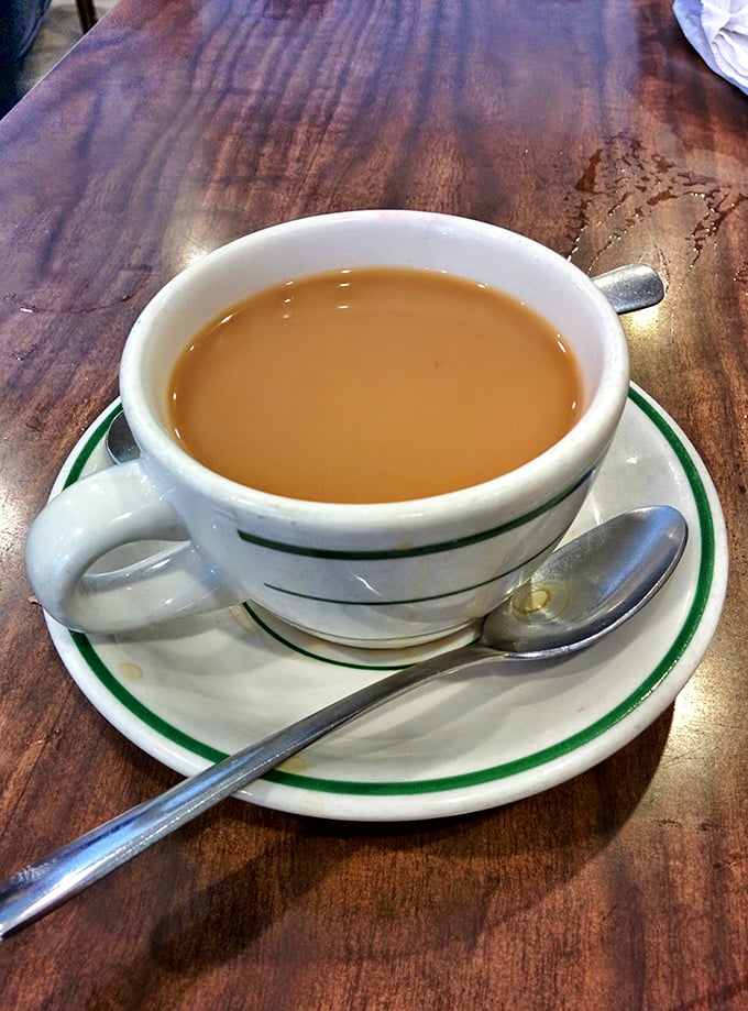 Coffee served in the classic green-striped mug – the unsung hero of breakfast, keeping Hot Springs locals and visitors equally caffeinated since forever.