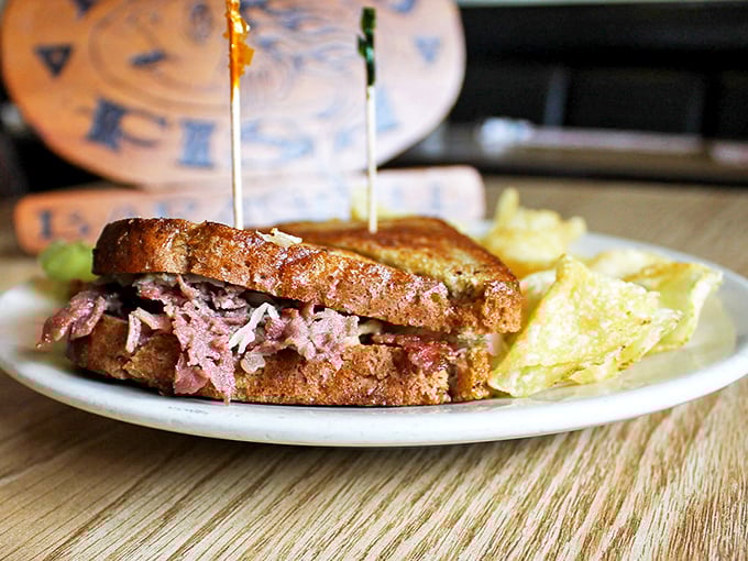 The Reuben: where sauerkraut and corned beef perform a perfect culinary tango on rye. Those chips aren't just sidekicks—they're co-stars.