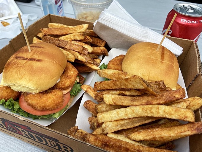 The humble cardboard carrier elevates from fast food to feast with sandwiches and hand-cut fries that deserve their own fan club.