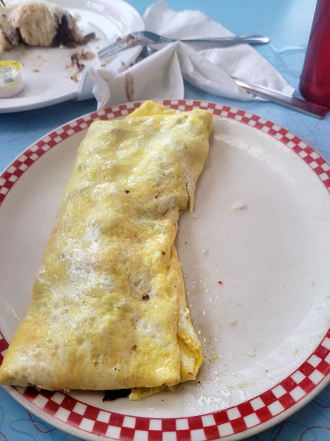 The Western omelet in its natural habitat—perfectly folded yellow exterior giving way to a treasure trove of fillings and a side of buttery toast.