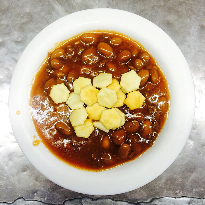 A bowl of beans with onions—proof that sometimes the side dish deserves its own standing ovation.
