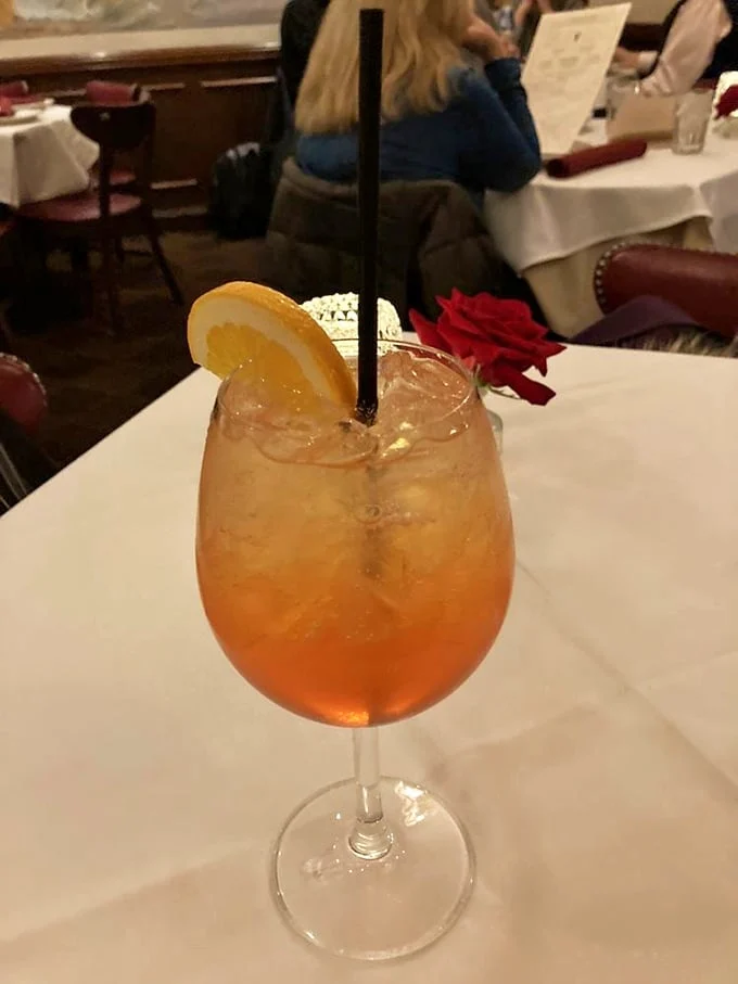 The kind of cocktail that makes you want to settle in for the evening. Amber liquid, citrus garnish, and a rose—because romance isn't dead at Gene & Georgetti.