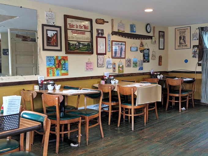 Wall decor collected over decades tells more stories than a library – each frame and trinket a chapter in Blairsville's community cookbook.