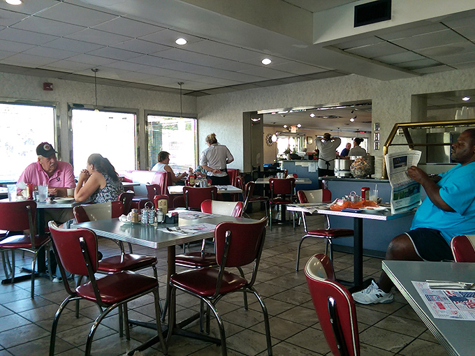 Classic diner ambiance with those unmistakable red chairs—where strangers become neighbors and everyone's connected by good food.