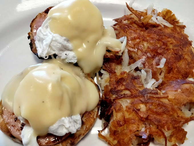 Eggs Benedict: where hollandaise cascades like a yellow waterfall over poached eggs, creating breakfast magic that makes mornings worthwhile.