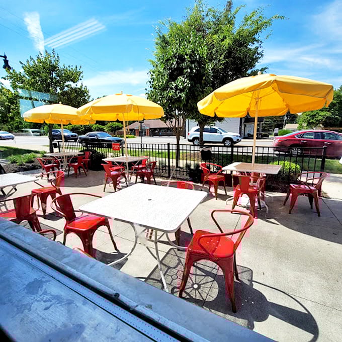 Summer dining al fresco under cheerful yellow umbrellas—because comfort food tastes even better with a side of sunshine and people-watching.