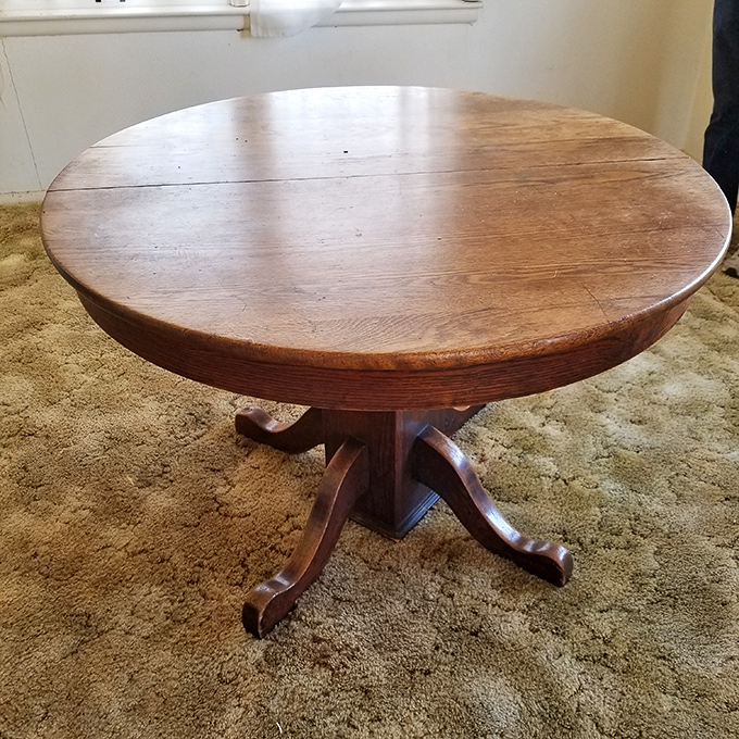 This oak pedestal table has hosted thousands of family dinners, card games, and homework sessions. If wood could talk, imagine the conversations it would share.