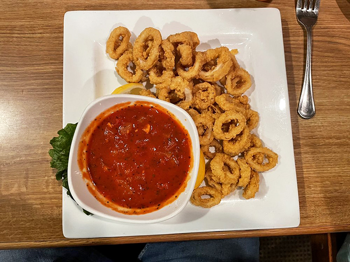 Crispy calamari rings with marinara aren't just an appetizer—they're edible life preservers rescuing you from the sea of ordinary restaurant starters.