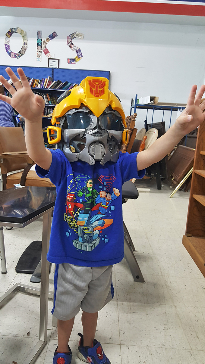 Somewhere beneath that Transformer mask is a child discovering the magic of reinvention – thrift stores are where imagination thrives.