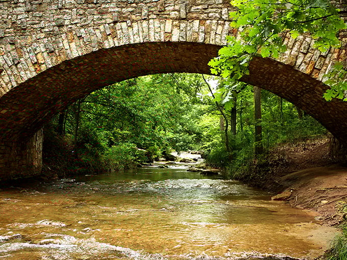 This stone arch bridge doesn't just span water—it connects present to past, standing as a testament to craftsmanship that has weathered decades of Oklahoma seasons.