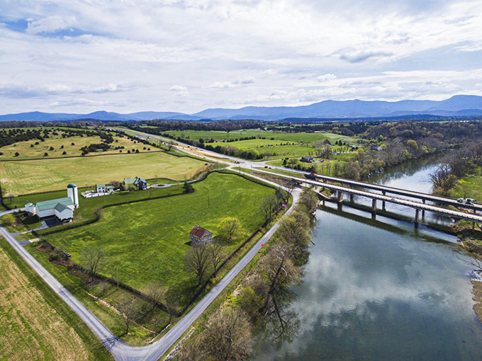 The bridge spanning the Shenandoah offers passage between worlds—from bustling town life to the serene countryside beyond.