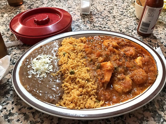 Camarones swimming in a sauce so vibrant it practically glows. Those shrimp didn't sacrifice themselves for nothing—this is seafood nirvana.