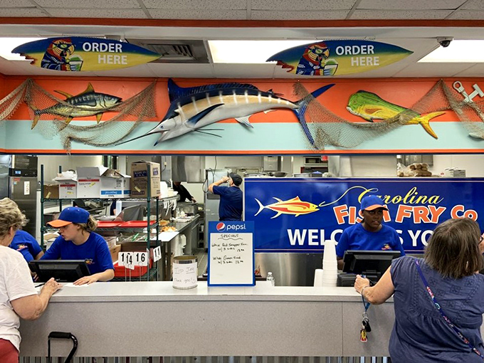 Where seafood dreams are fulfilled – the bustling counter area with mounted fish watching over the proceedings.