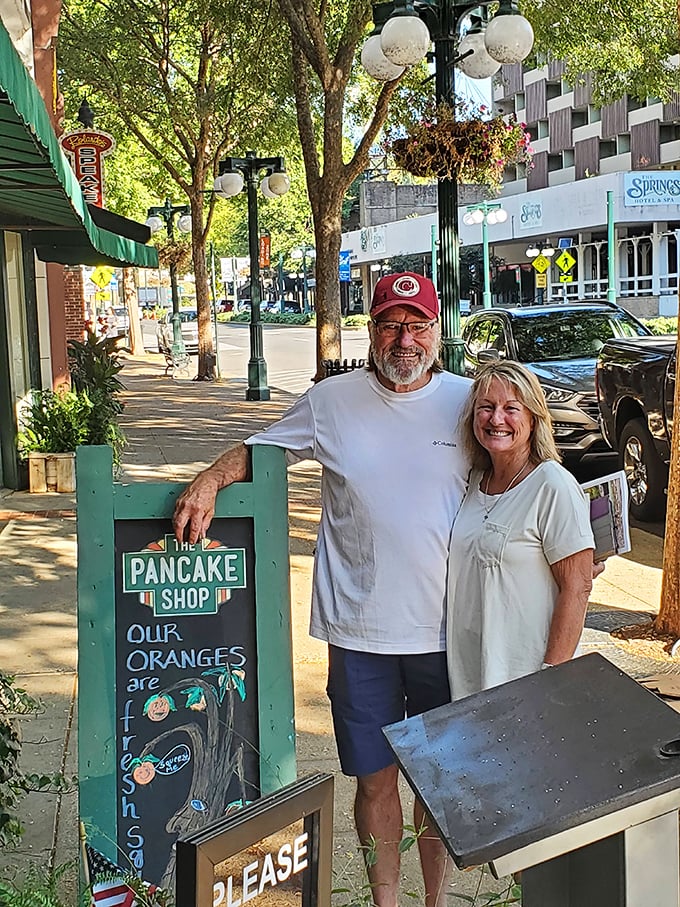 The sign outside promises fresh oranges, and these happy customers found that and more – the universal expression of post-pancake satisfaction.