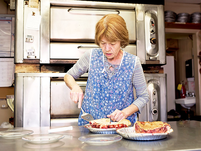 Behind every perfect pie is a skilled hand and years of practice—this is where the magic happens, one crimped edge at a time.