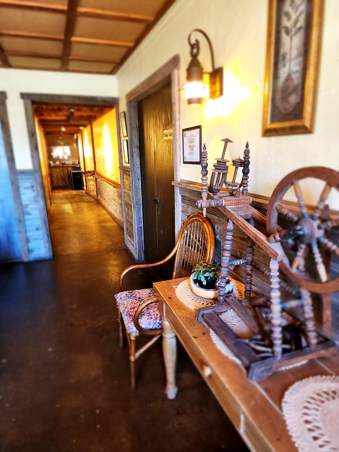 The hallway connecting dining rooms could be a museum of Americana, complete with spinning wheel and warm, amber lighting.