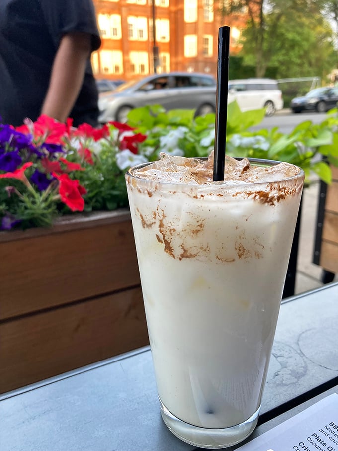 This isn't just a milkshake—it's a creamy revelation in a glass, garnished with possibility and window-side flowers.